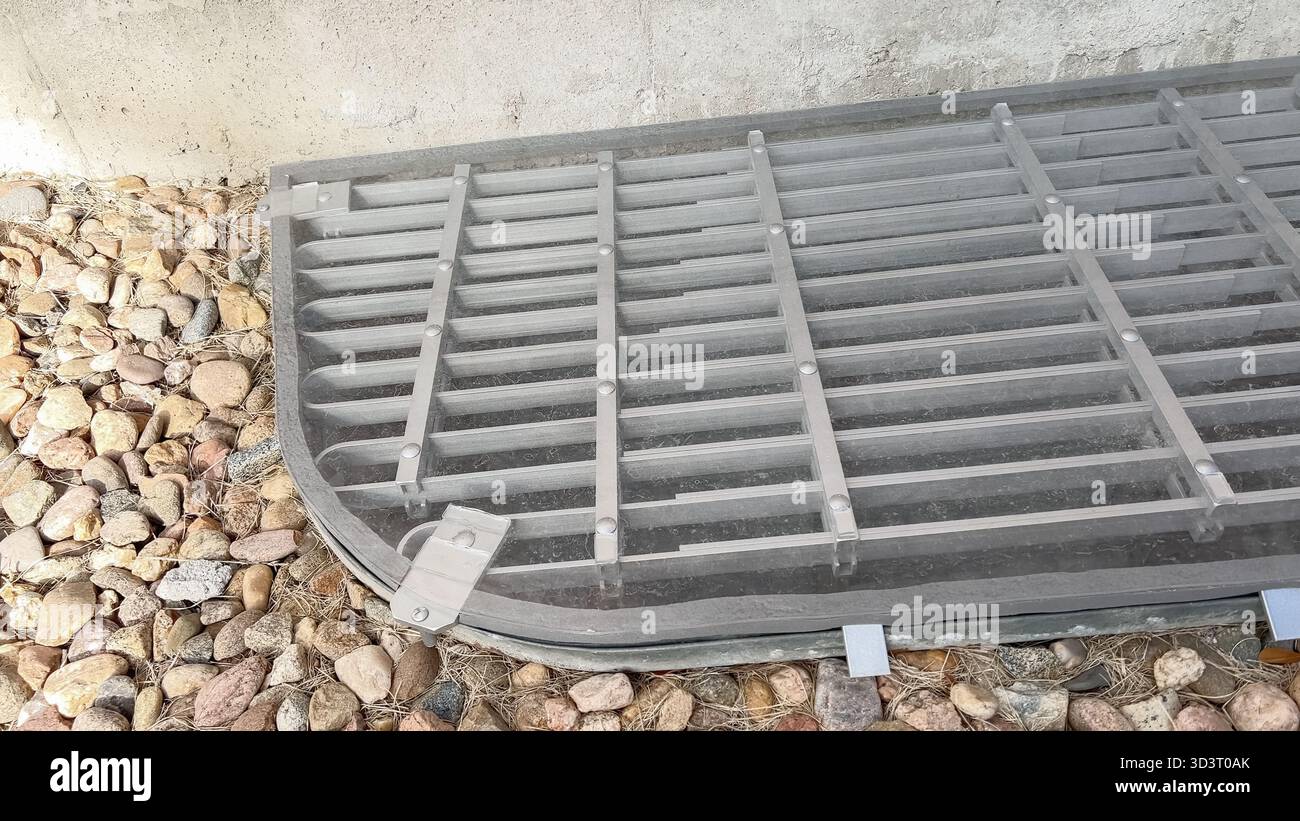 Window Well Grate Installed on Rocky Ground Stock Photo - Alamy