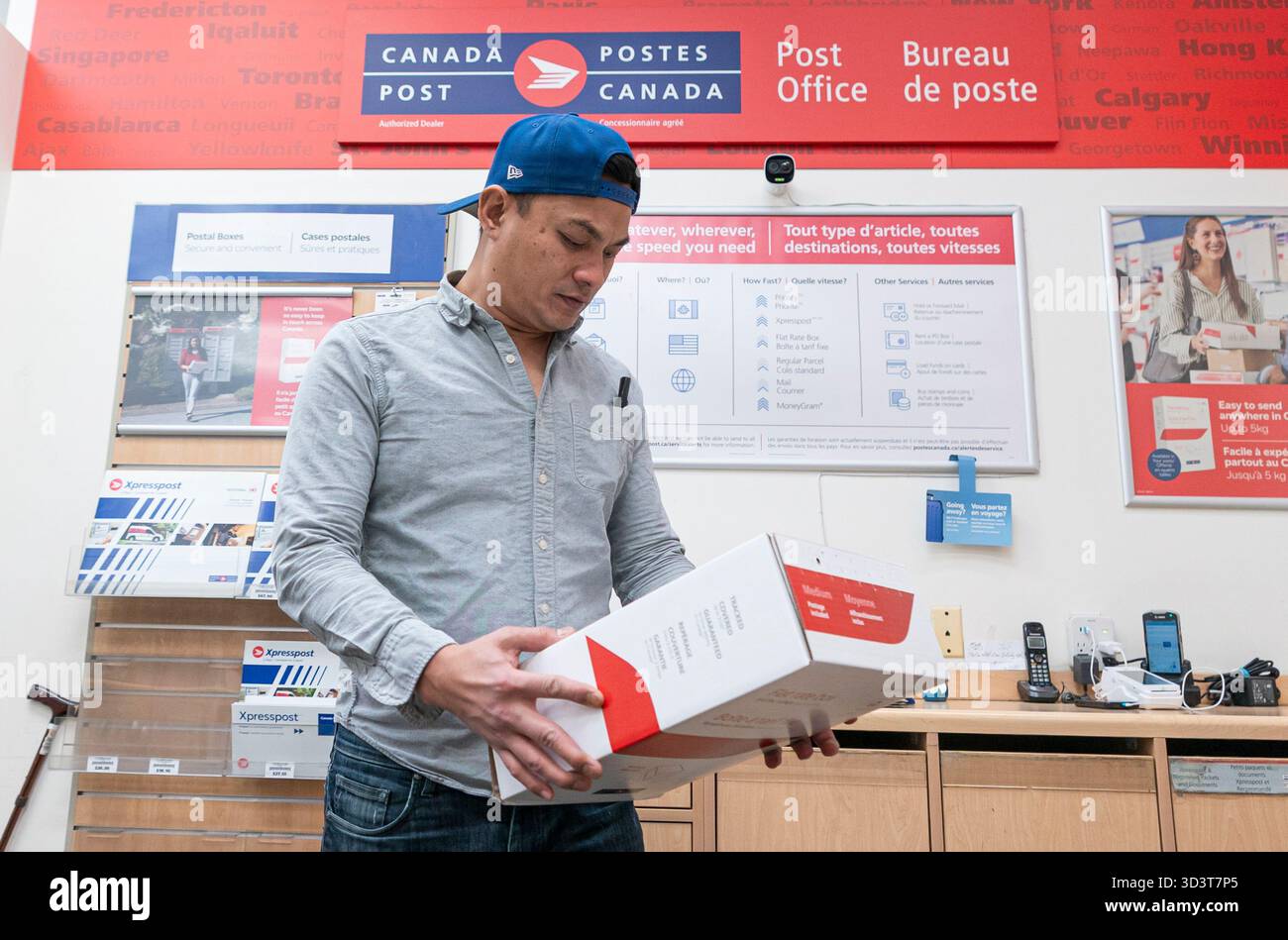 Mark Binay, co-owner of the Canada Post office in Chinatown, sorts a ...
