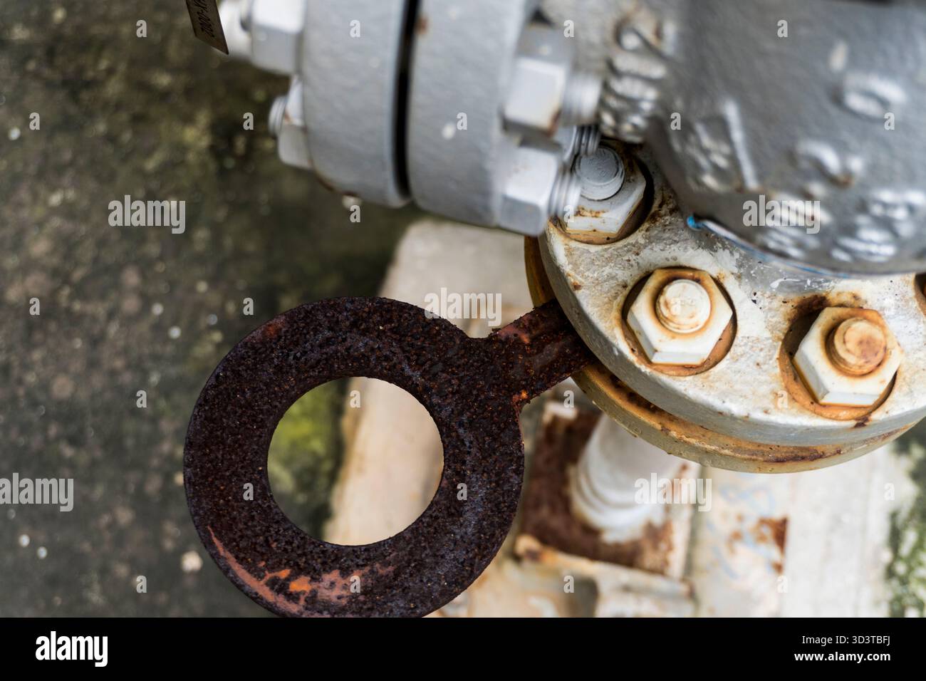Rusty pipe with a bolt on it. The bolt is missing. The pipe is old and ...