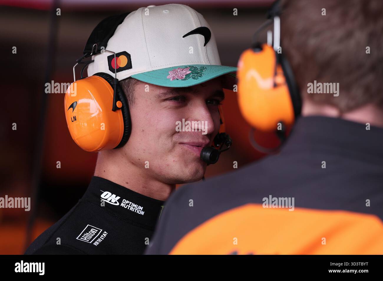 McLaren driver Lando Norris of Britain stands in the pit during a ...