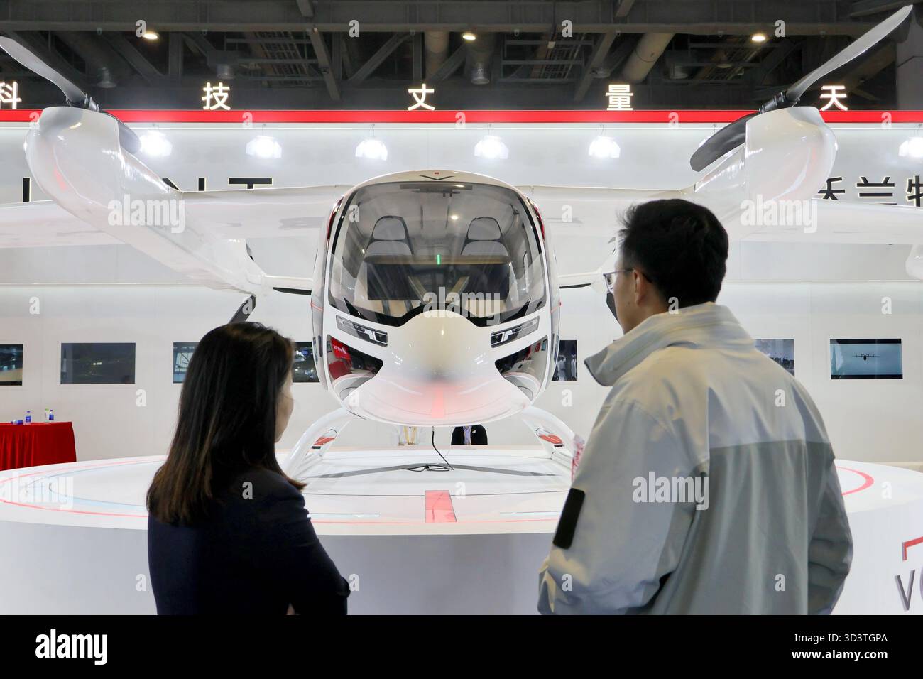 Visitors check out the eVTOL Volant VE25-100 at China International Import Expo in Shanghai ...
