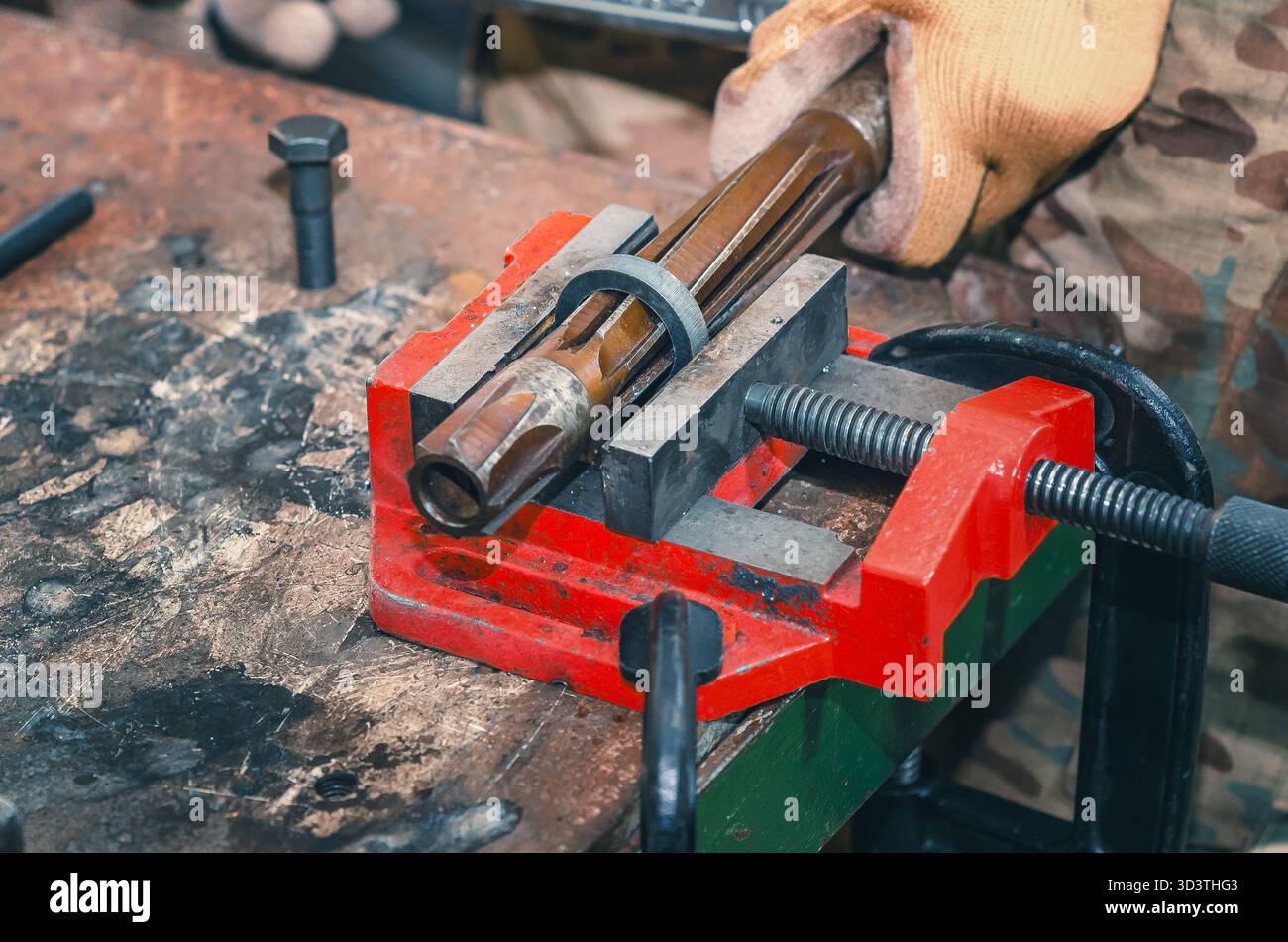Welding vice. Close-up of red table-top vice with screw handle and cast ...