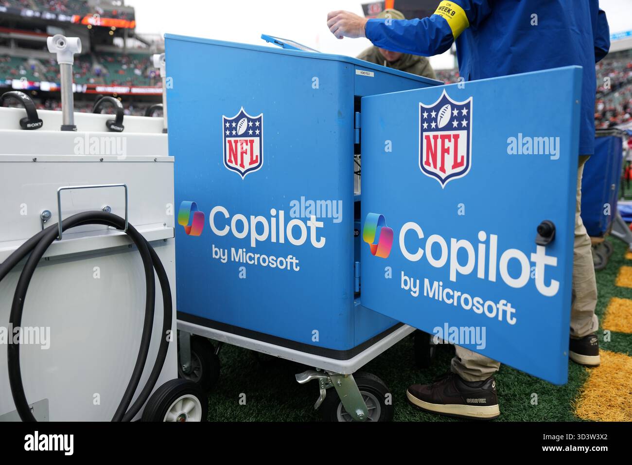 Sideline personnel prepare for the game using Microsoft Copilot ...