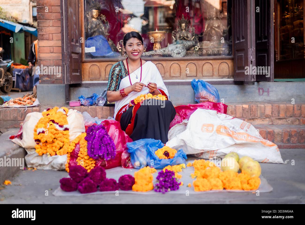 Newari Girl in traditional attire Crafting Globe Amaranth Garlands ...