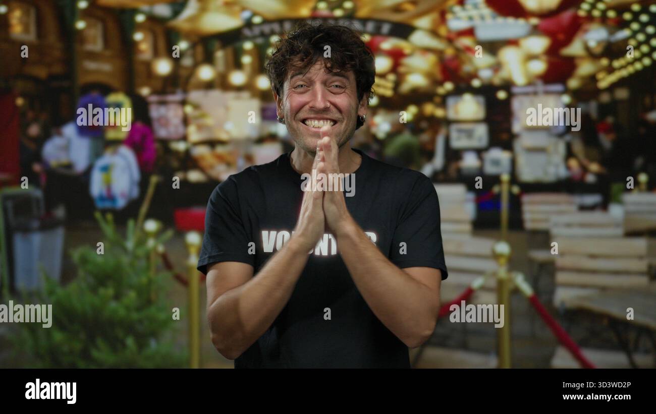Hispanic man celebrating in a vibrant shopping mall wearing a volunteer ...