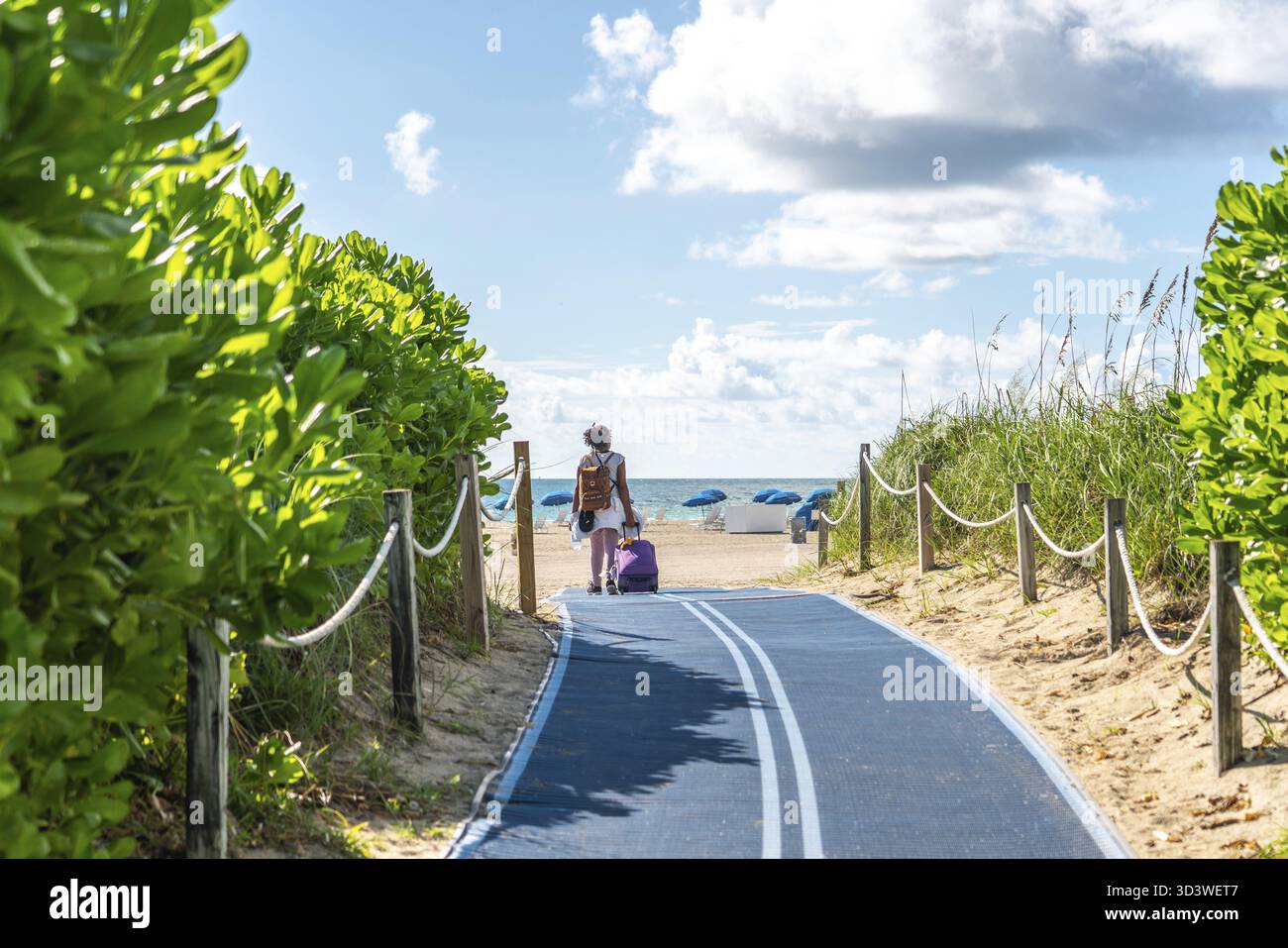 Woman walking to the beach on Footpath. South Beach in Miami, Florida ...