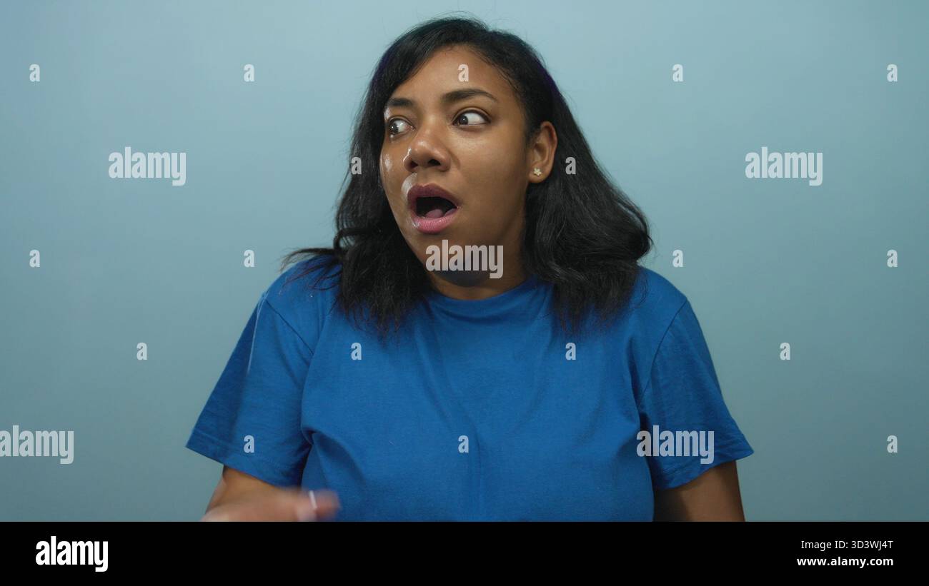 African american woman raises hand to her forehead while closing eyes ...