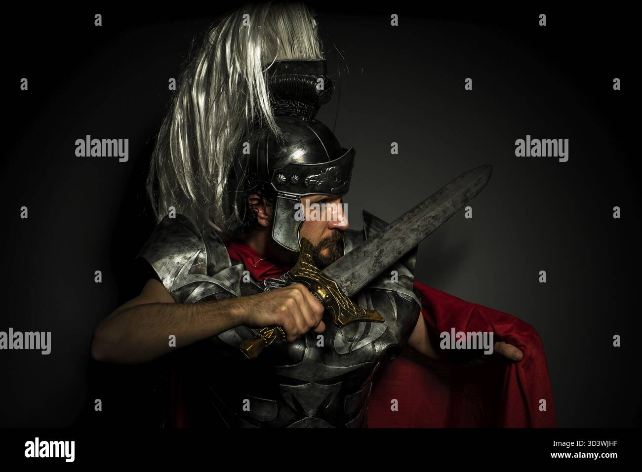 Roman centurion with armor and helmet with white chalk, steel sword and ...