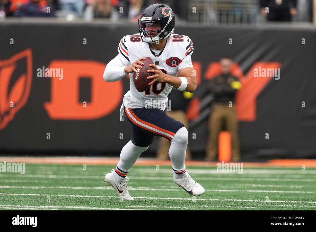 Chicago Bears quarterback Caleb Williams (18) runs out of the pocket to ...