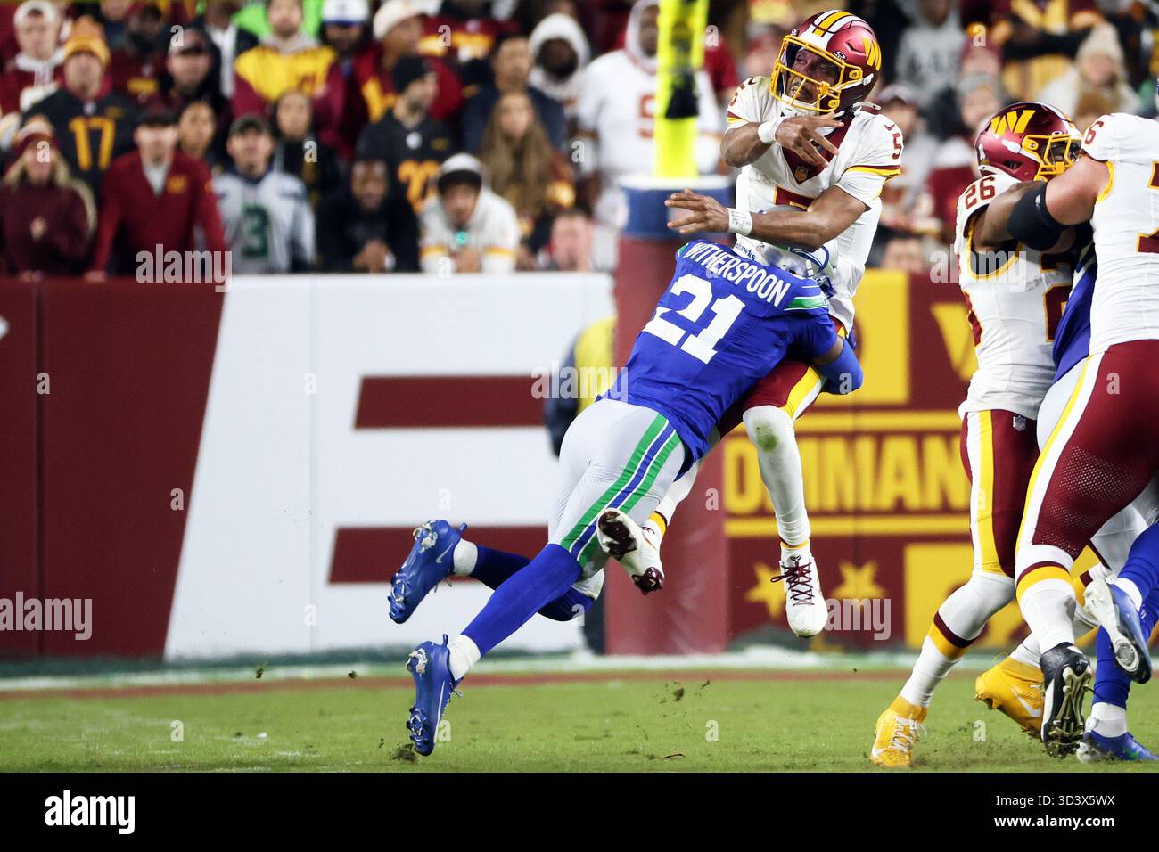 Seattle Seahawks cornerback Devon Witherspoon (21) lays a hard hit on ...