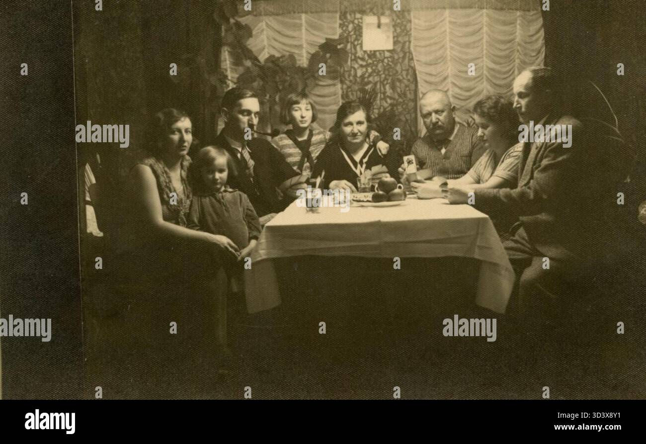 A family gathering of the Romanowski and Bystro families around a table ...