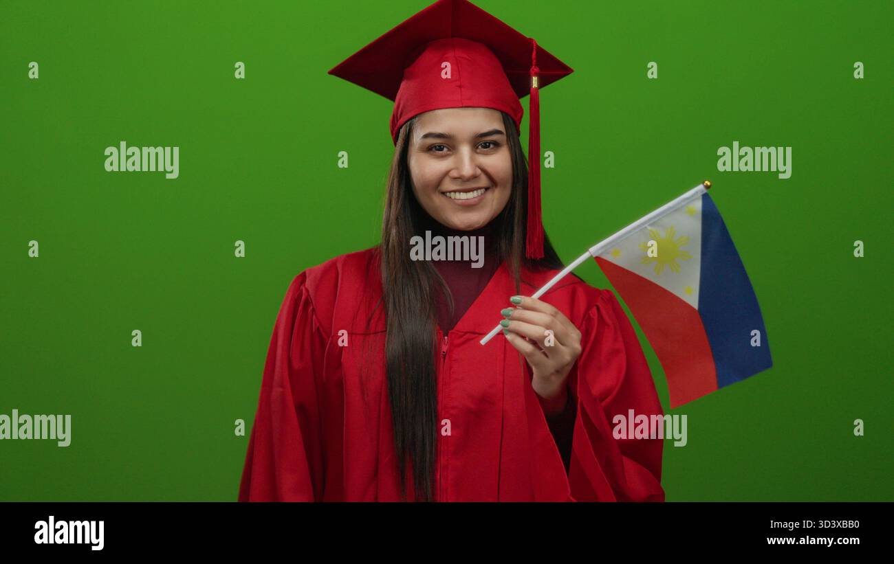 Woman in red graduation gown holding philippine flag against green ...