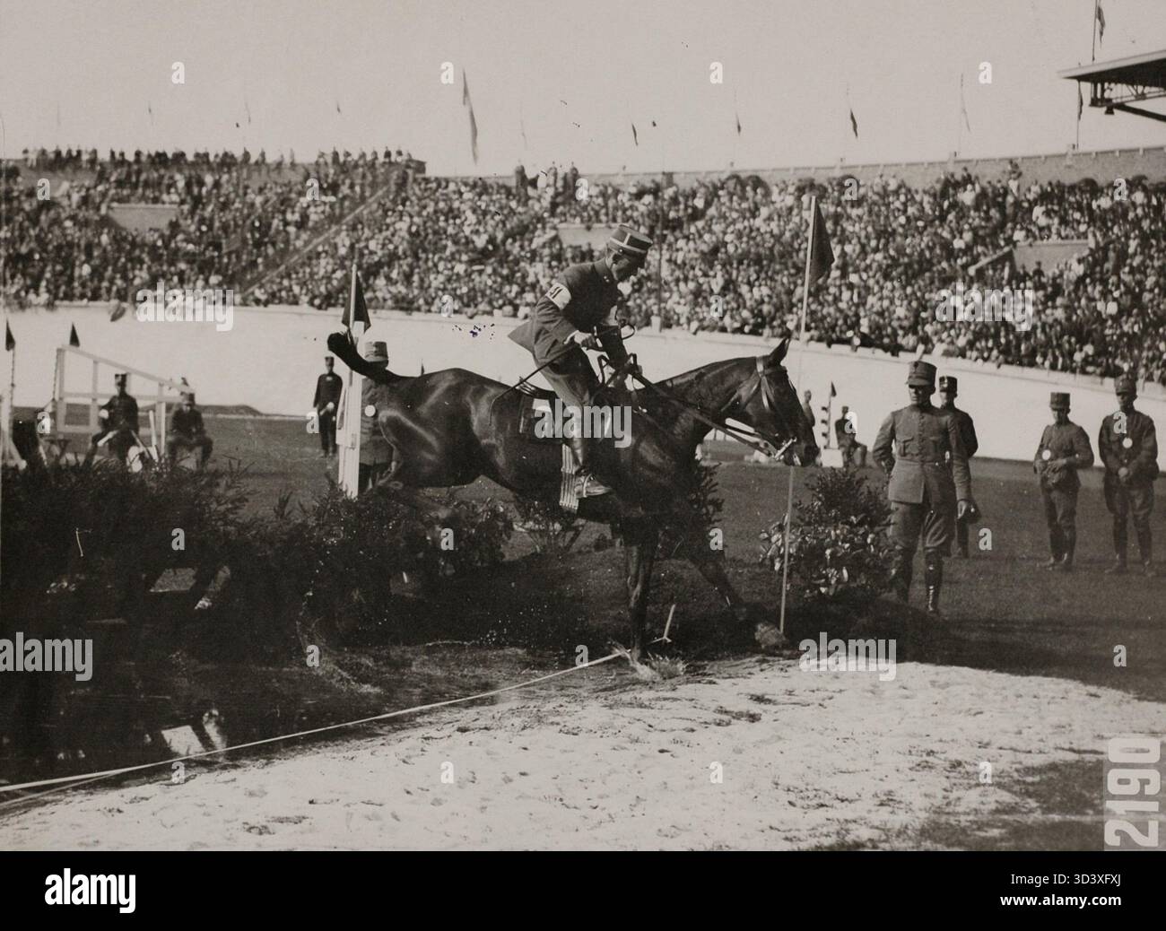 Swedish rider S. Colliander clears a water obstacle with his horse at ...