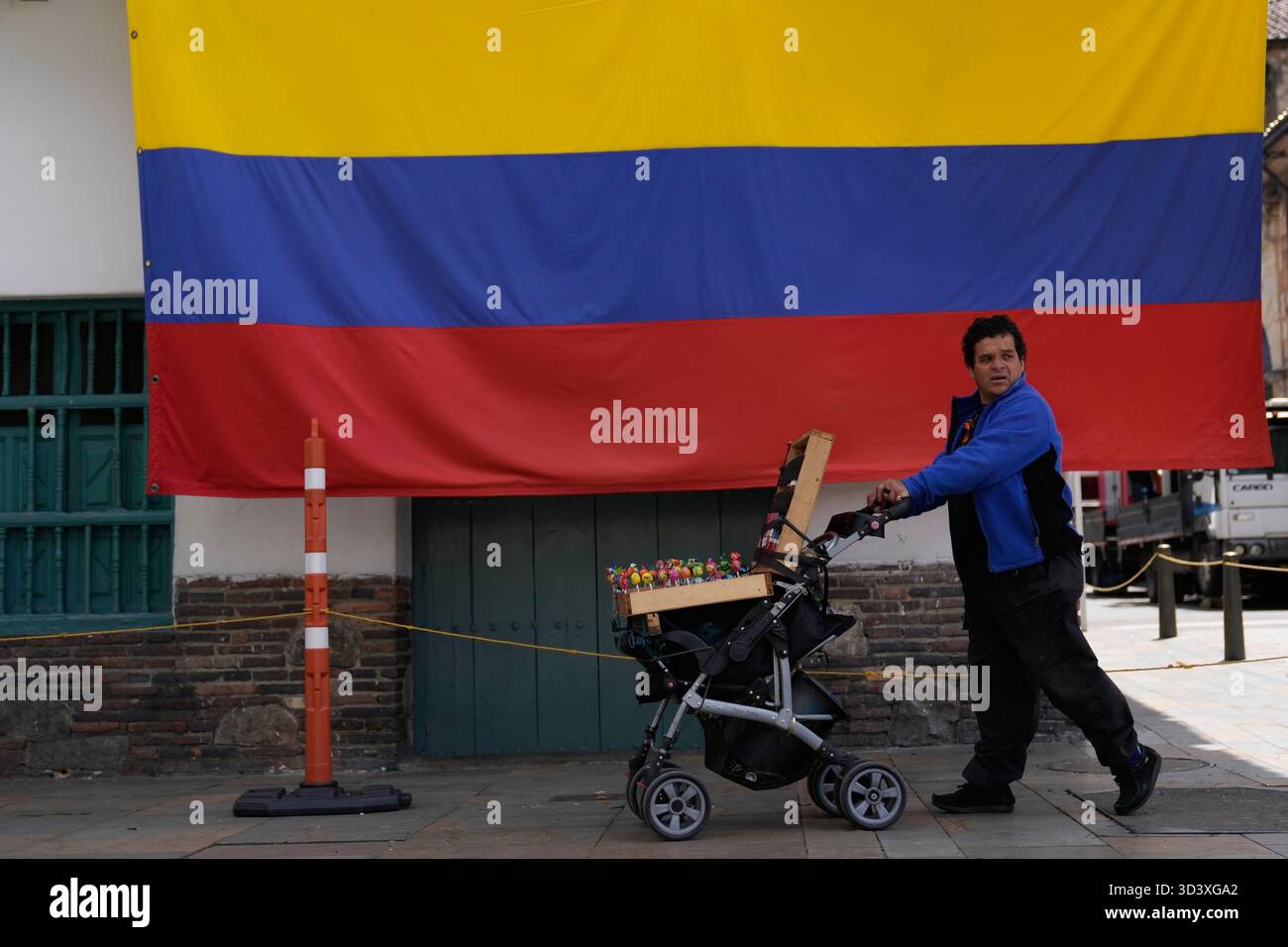 A street vendor pushes his cart of candies and cigarettes past a ...