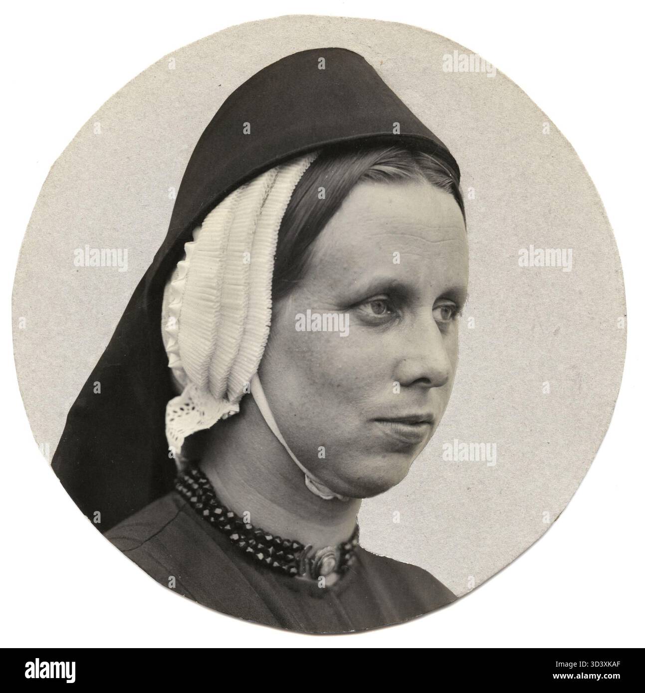 A woman from Terschelling wears a traditional bonnet, characteristic of ...