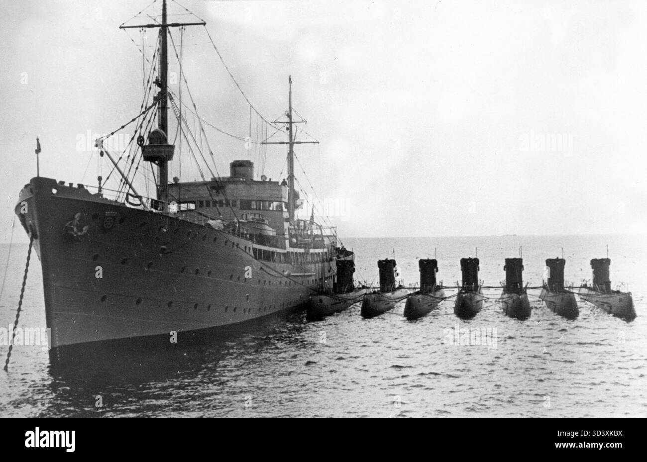 A 1939 photo shows a German submarine tender with seven smaller ...