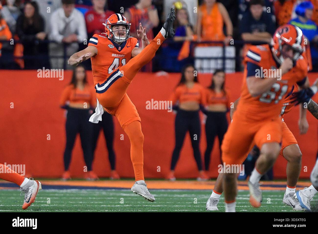 Syracuse punter Jack Stonehouse (41) punts during the first half of an ...