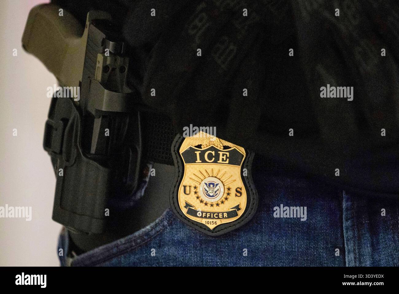 FILE - A federal agent wears an Immigration and Customs Enforcement ...