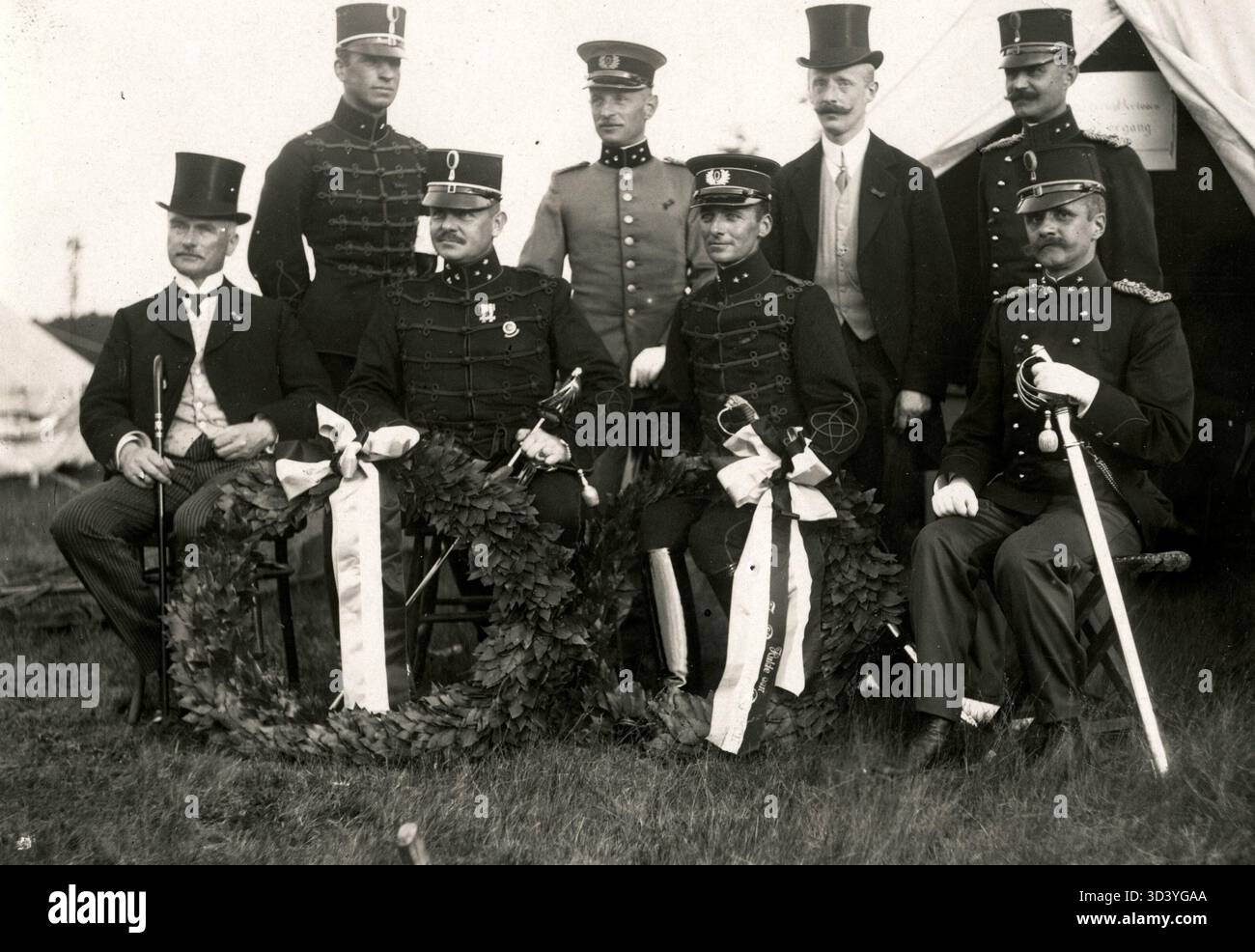 A group of senior military officers in uniform and civilians in formal ...