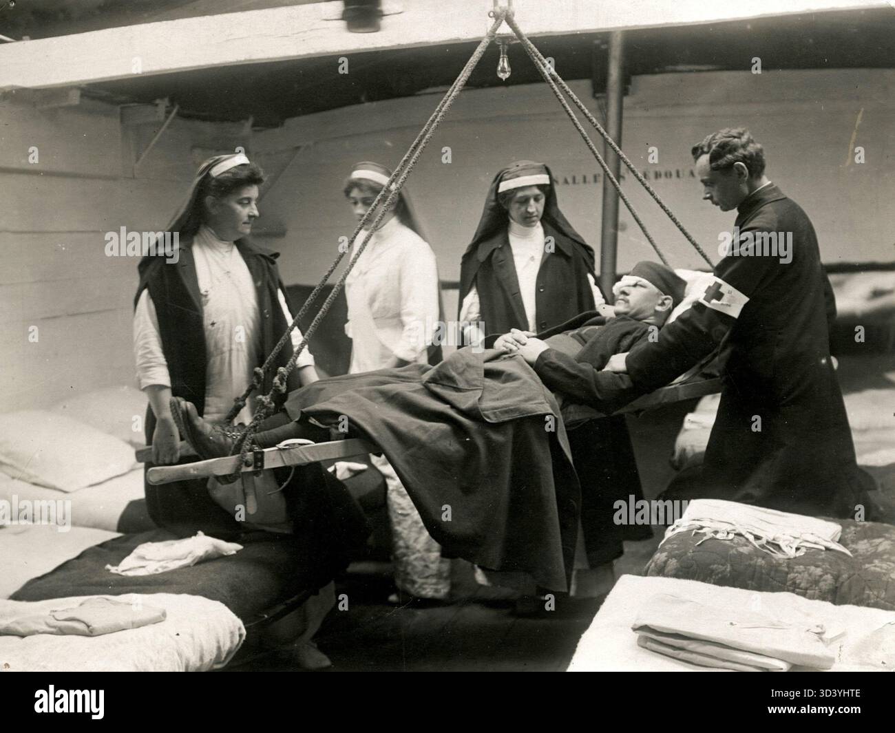 During World War I in 1914, a wounded soldier is lowered into the hold ...