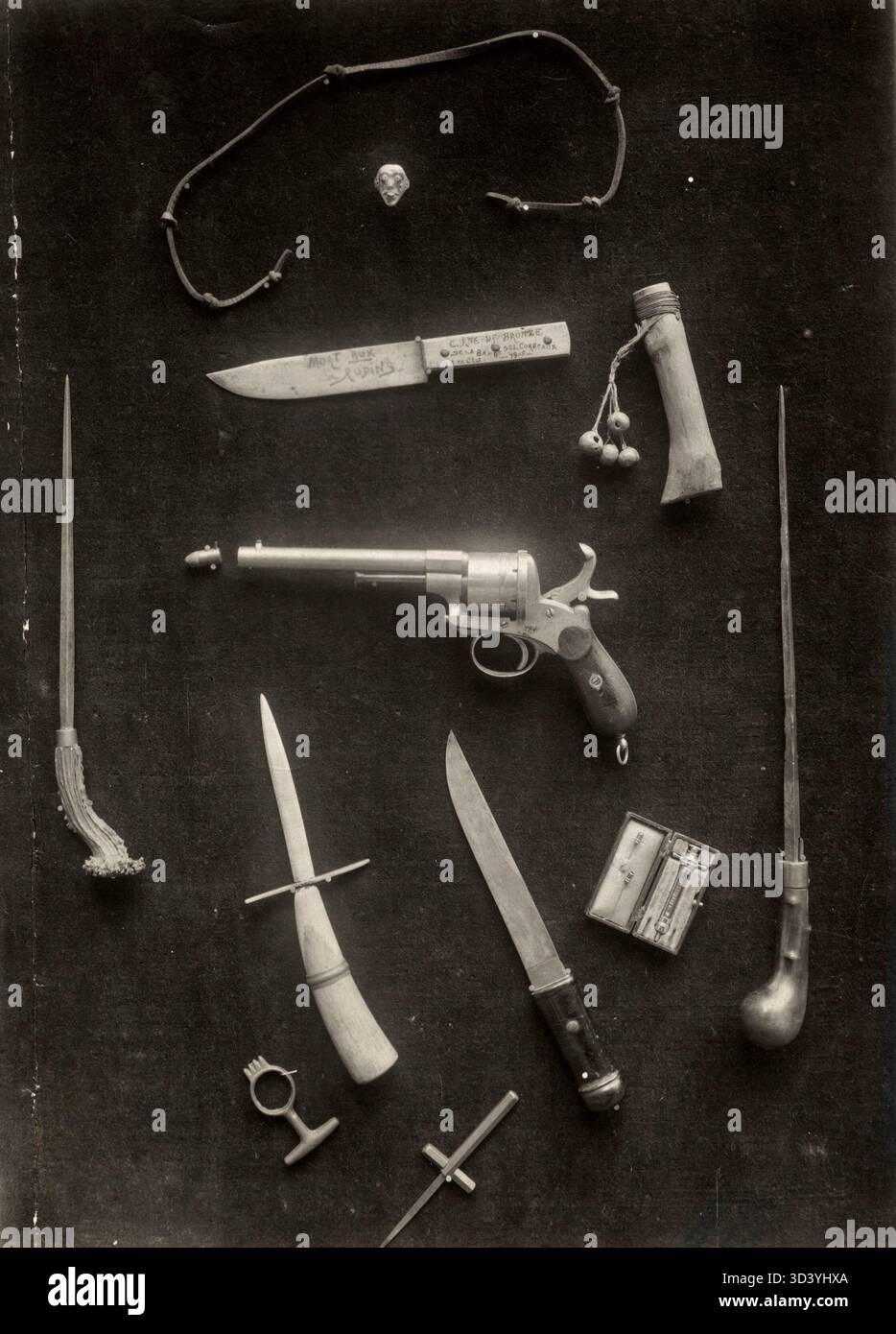 A selection of displayed weapons, including knives and a pistol ...