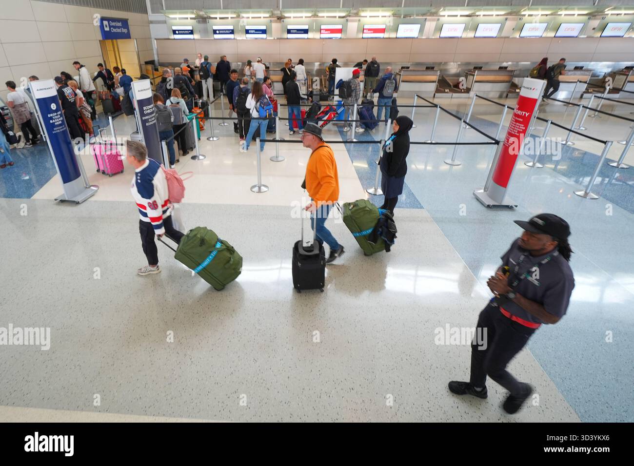Travelers check in for flights at Terminal D of Dallas Forth Worth ...