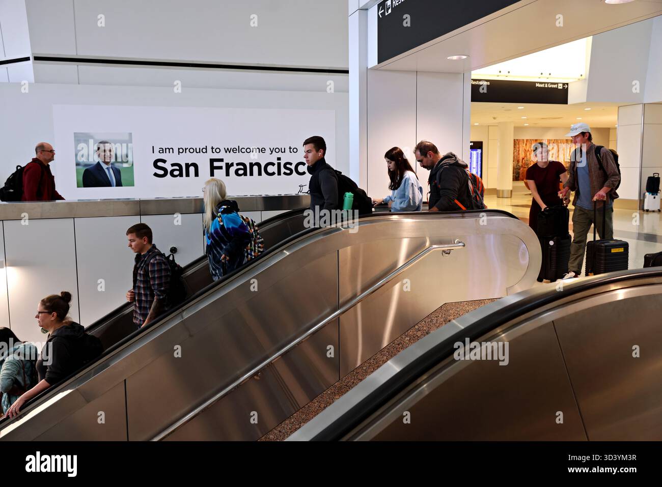 Travelers take the escalator at San Francisco International Airport on ...