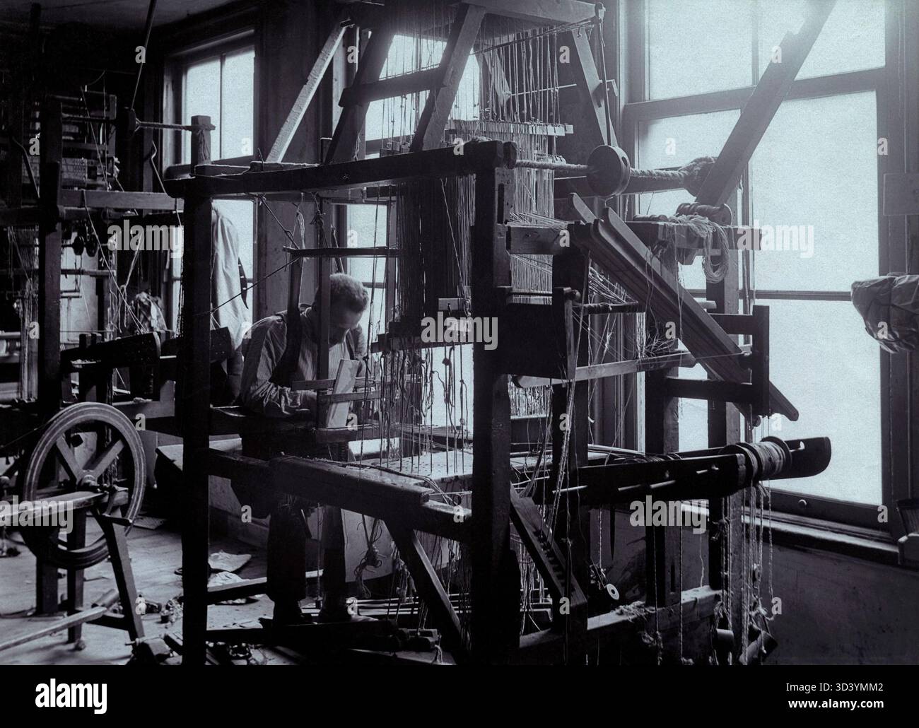 A man is pictured operating a weaving loom in the Knuijver & Zonen ...