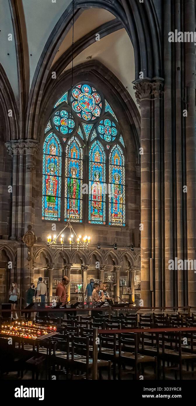 Stunning stained glass windows cast colorful light across a historic ...