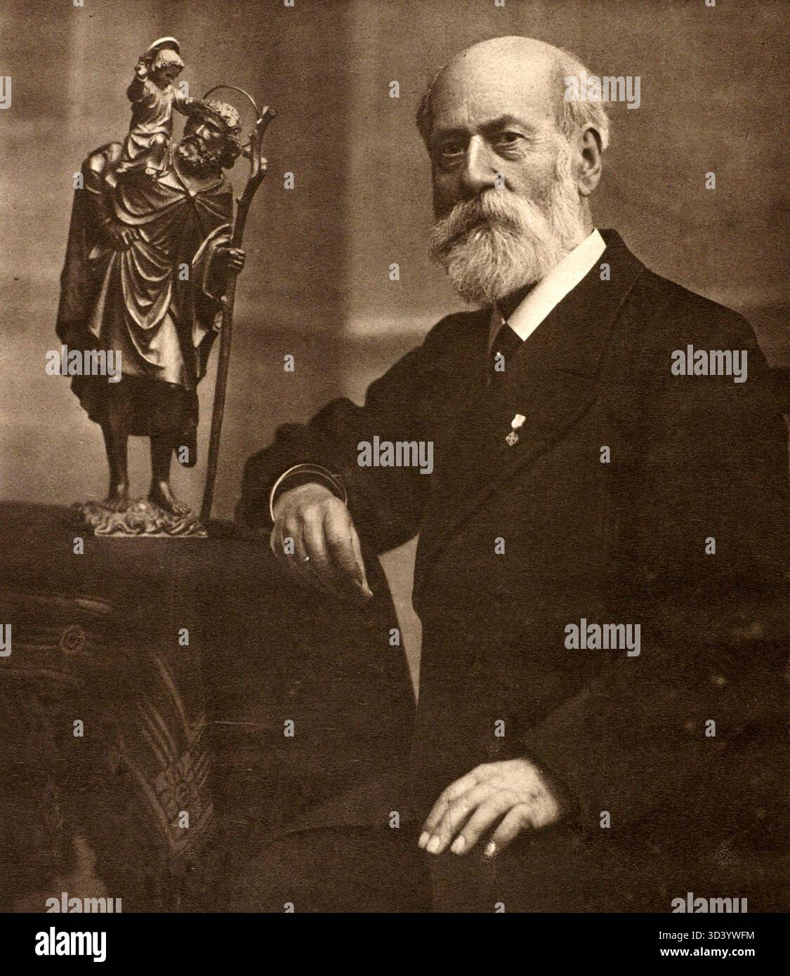 Dutch sculptor Jos Thissen Sr. (1840-1920) sitting next to a small ...