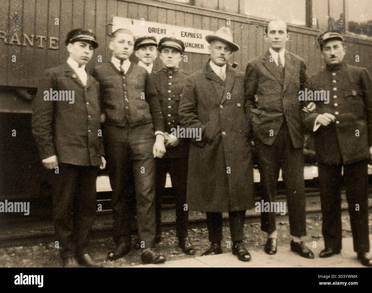 Passengers and staff of the Orient Express stand by the train at a ...