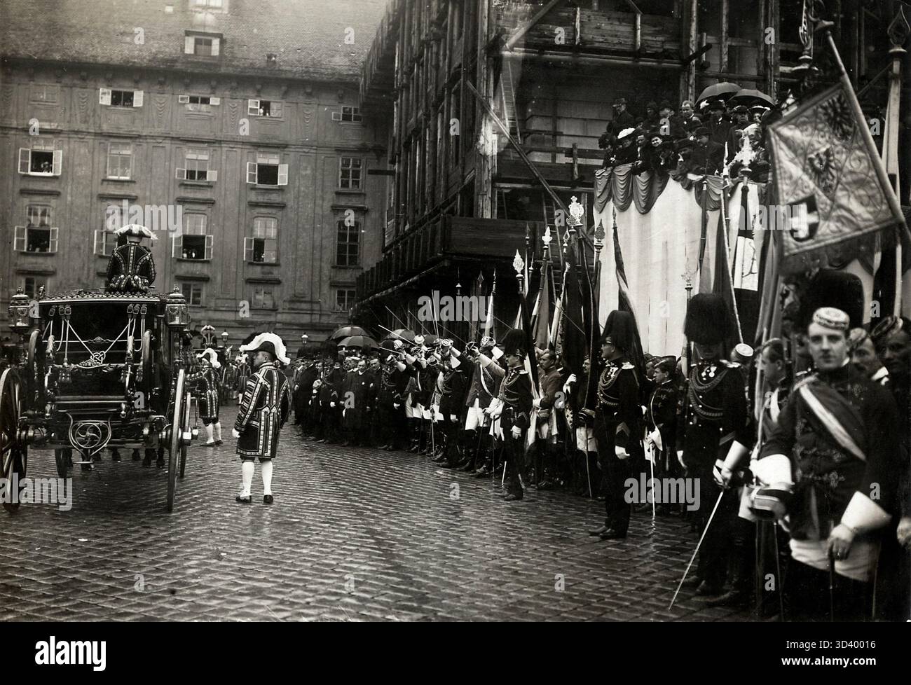 An honor guard salutes with drawn sabers as carriages with ...