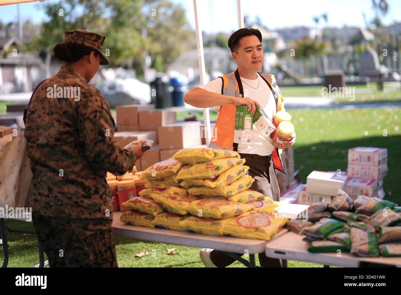 Volunteer Angus Hsigh helps a military member during a Feeding San ...