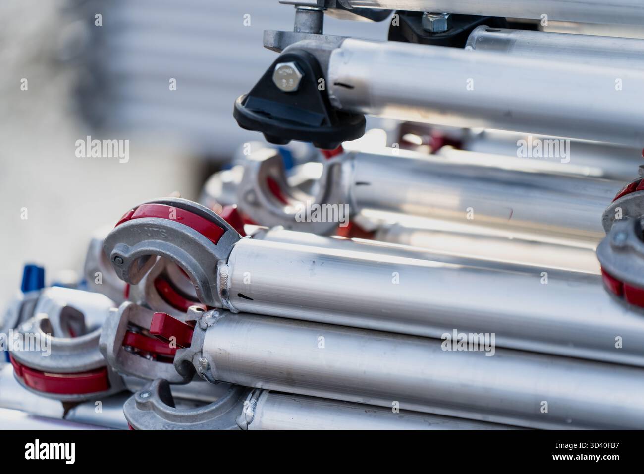 Pile of metallic scaffolding tubes with clamps and connectors ...