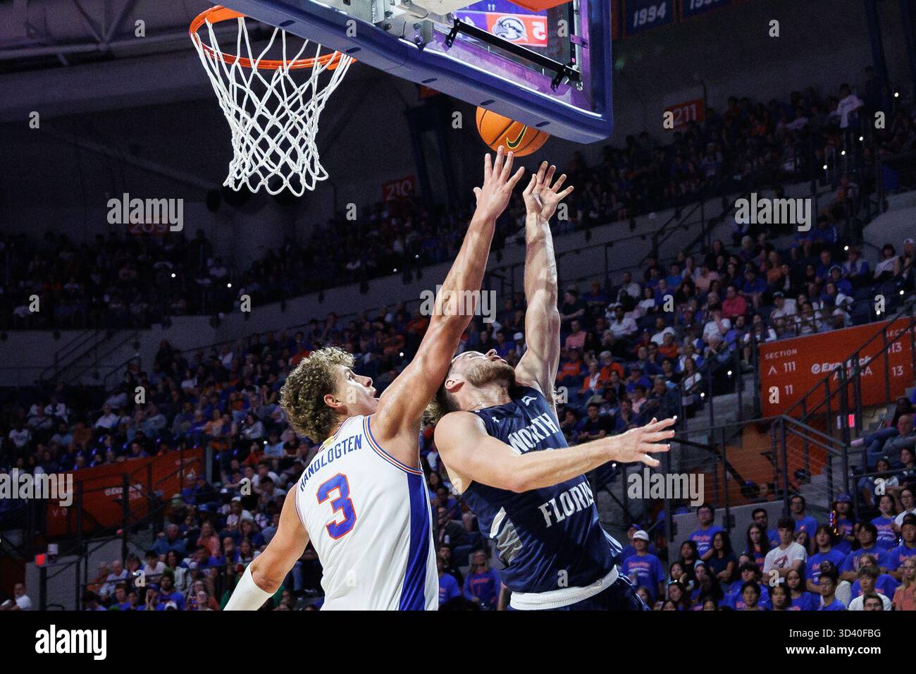 Florida center Micah Handlogten (3) tips a shot by North Florida guard ...