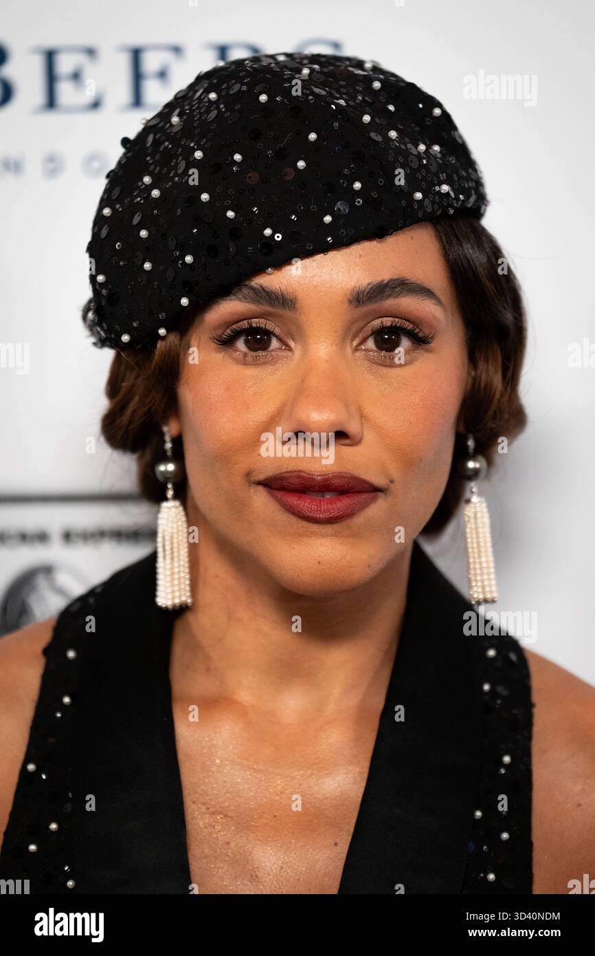 Alex Scott poses for photographers upon arrival at the Harper's Bazaar ...