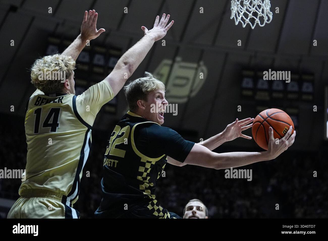 Oakland forward Isaac Garrett (32) shoots around Purdue guard Jack ...
