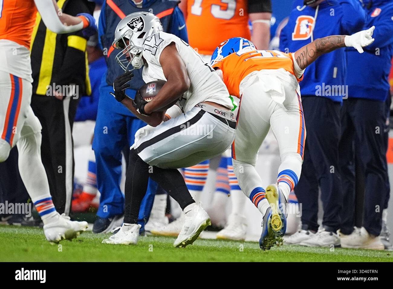 Las Vegas Raiders wide receiver Tyler Lockett (17) avoids a tackle by ...