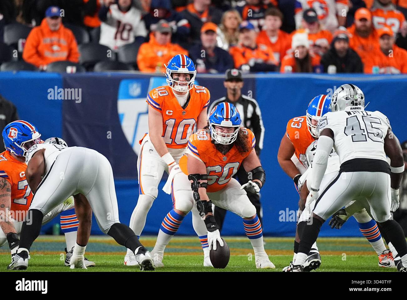 Denver Broncos quarterback Bo Nix (10) takes the snap from center Luke ...