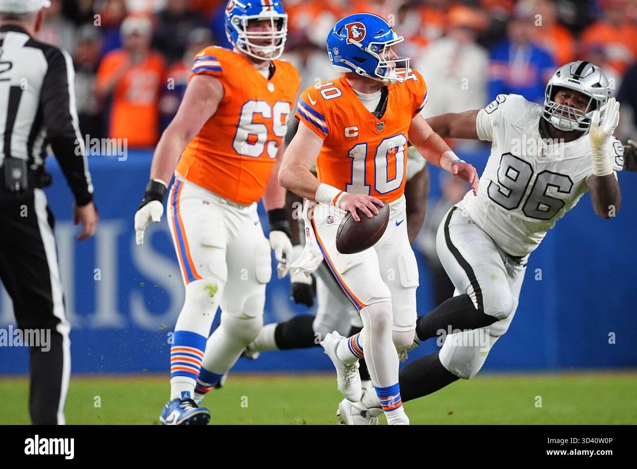 Denver Broncos quarterback Bo Nix (10) and Las Vegas Raiders defensive tackle Jonah Laulu (96 ...