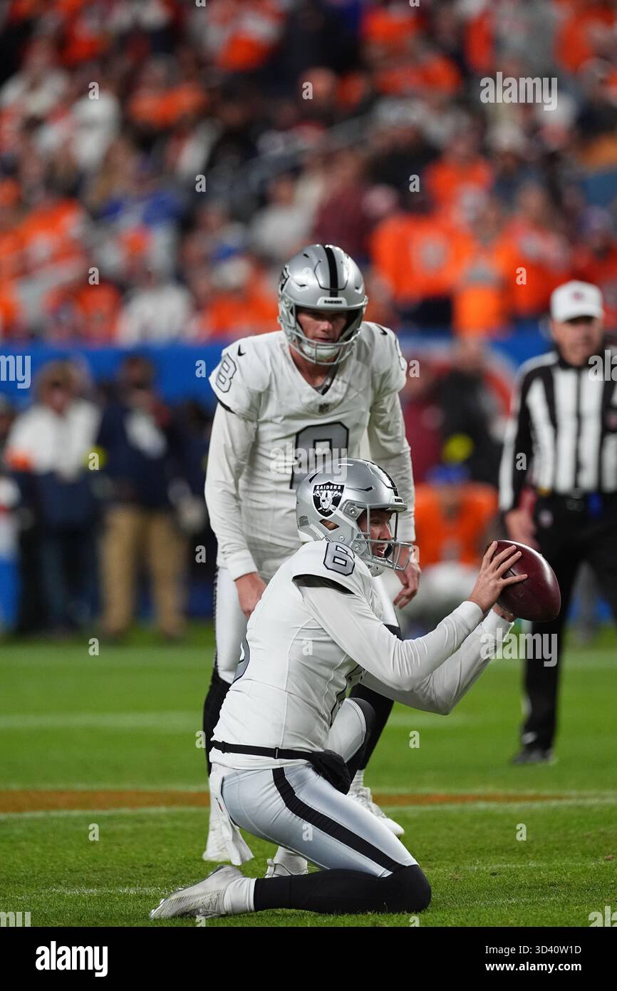 Las Vegas Raiders punter AJ Cole (6) fields the snap before setting the ...