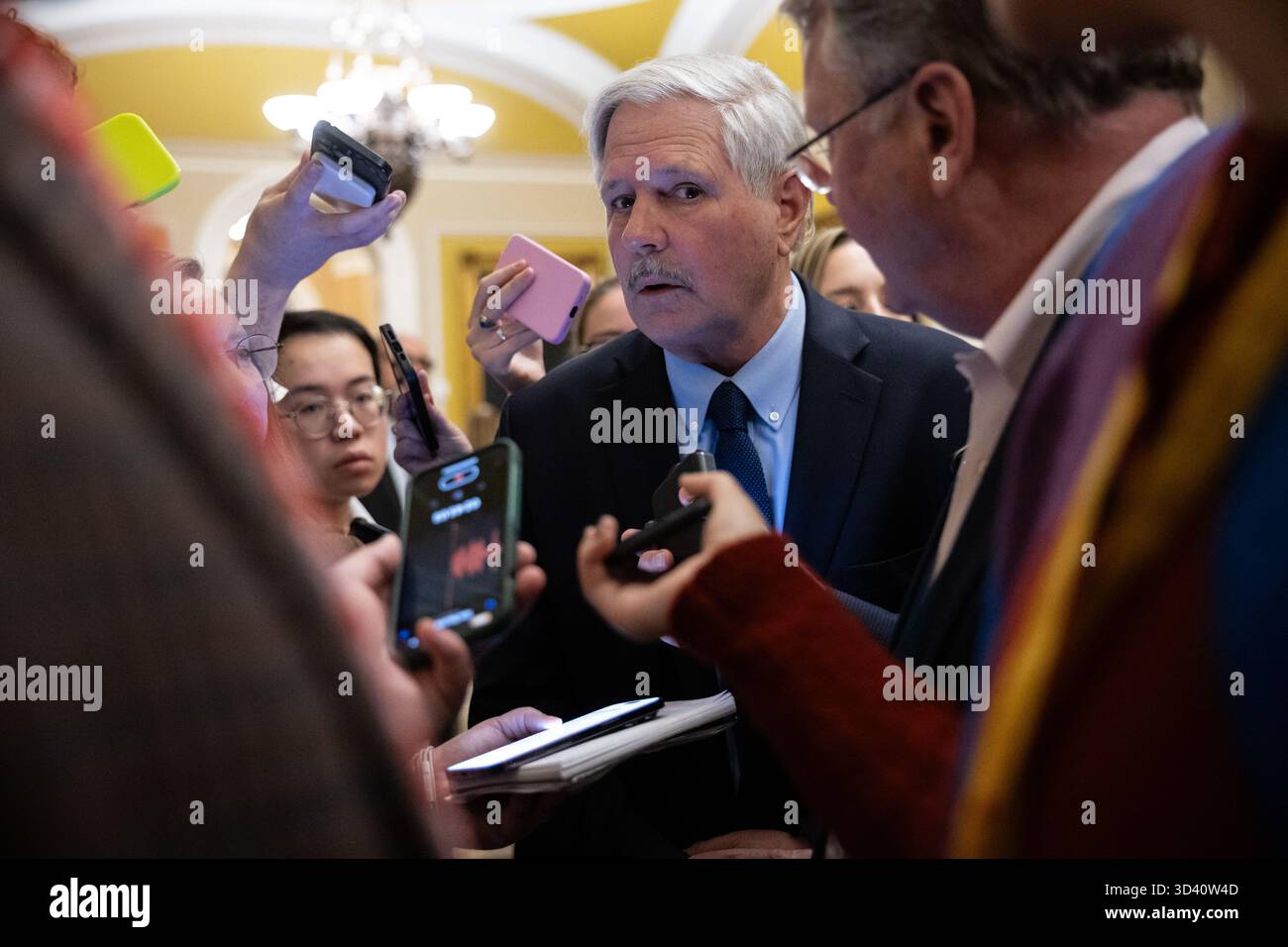 Sen. John Hoeven (R-N.D.) speaks with reporters as he departs a Senate ...