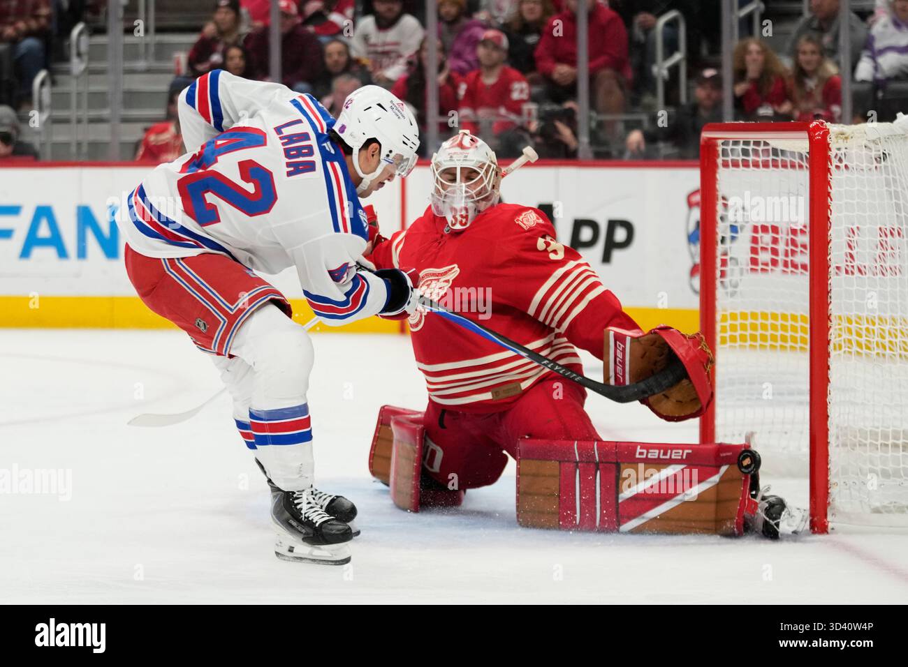New York Rangers center Noah Laba, left, shoots against Detroit Red ...