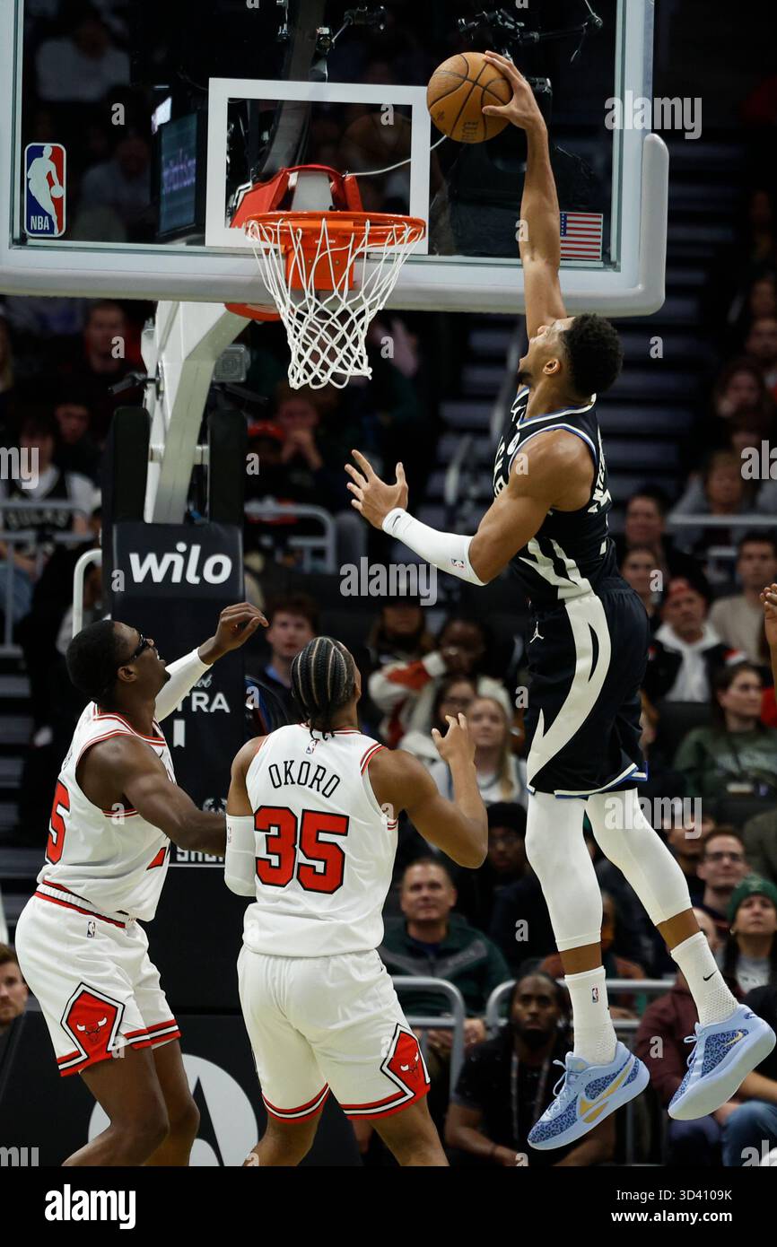 Milwaukee Bucks' Giannis Antetokounmpo, right, dunks against the ...