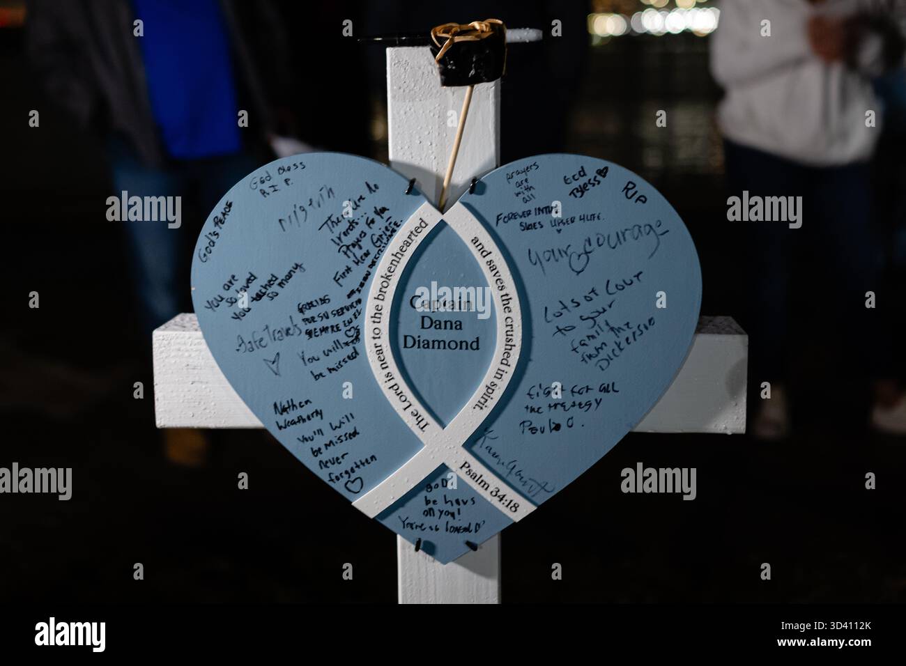 A placard and cross honoring Capt. Dana Diamond is seen during a vigil ...