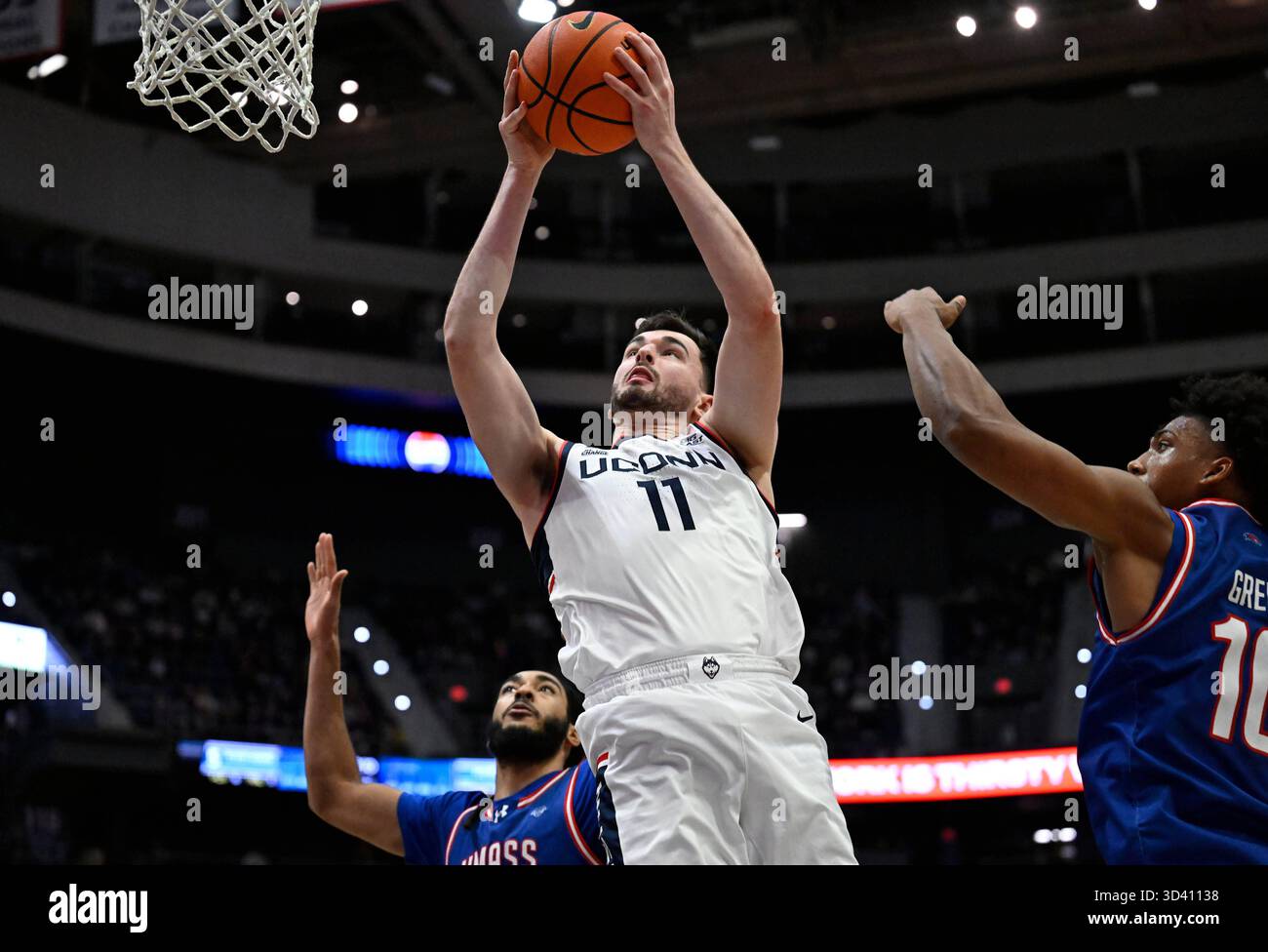 UConn forward Alex Karaban (11) goes up for a basket against UMass ...