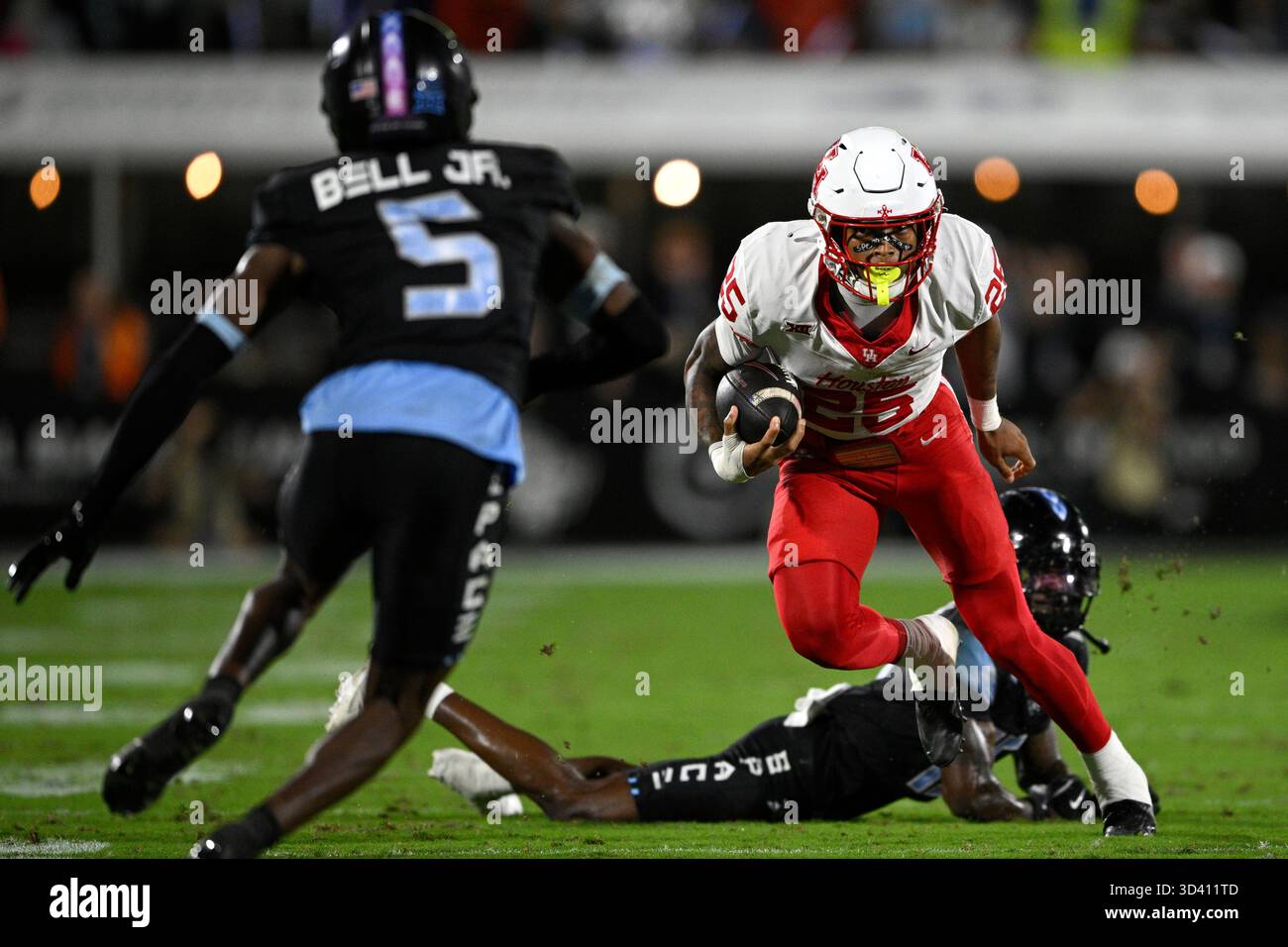 Houston running back DJ Butler (25) rushes for yardage between Central ...
