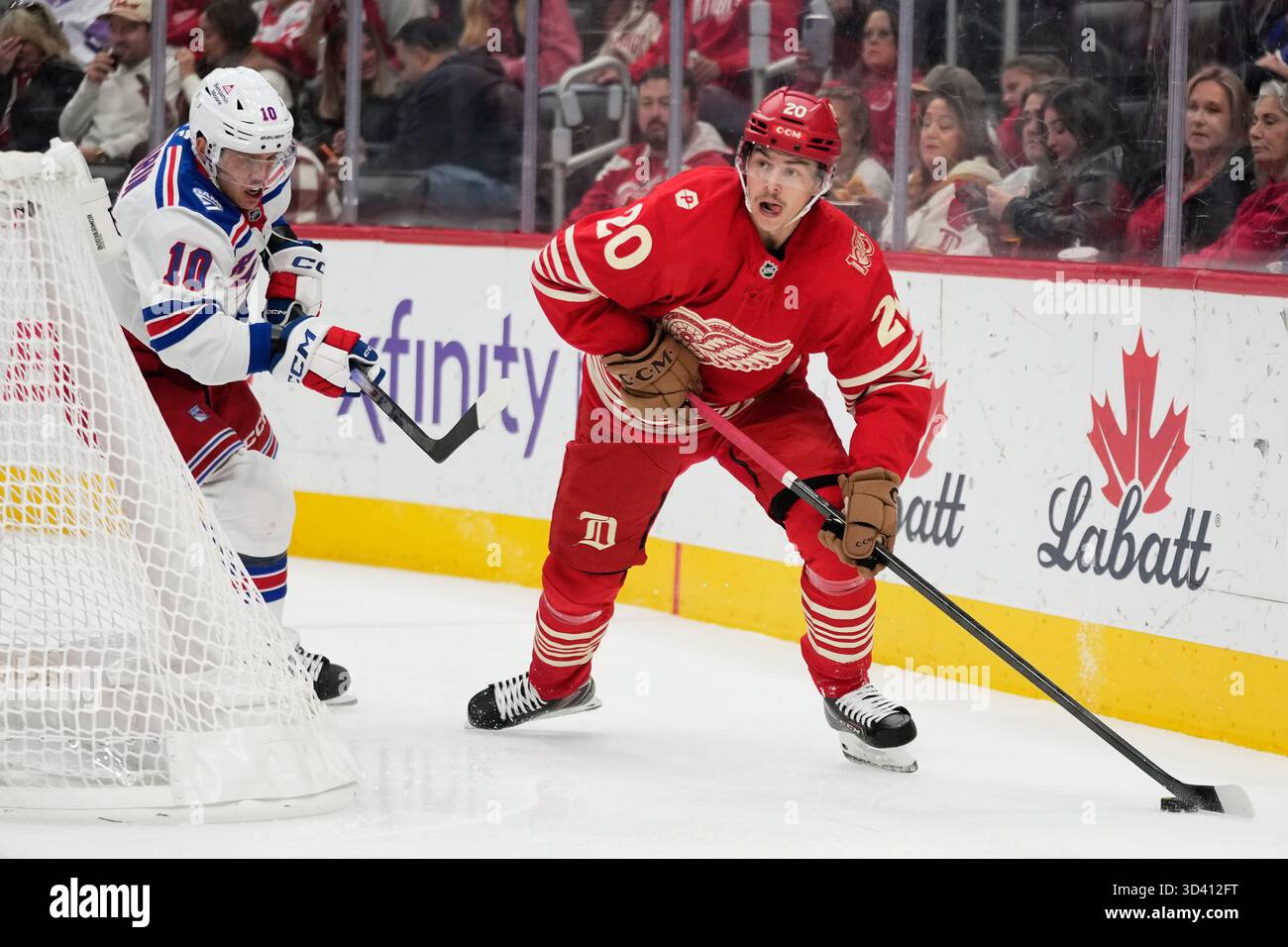 Detroit Red Wings defenseman Albert Johansson, right, moves the puck ...