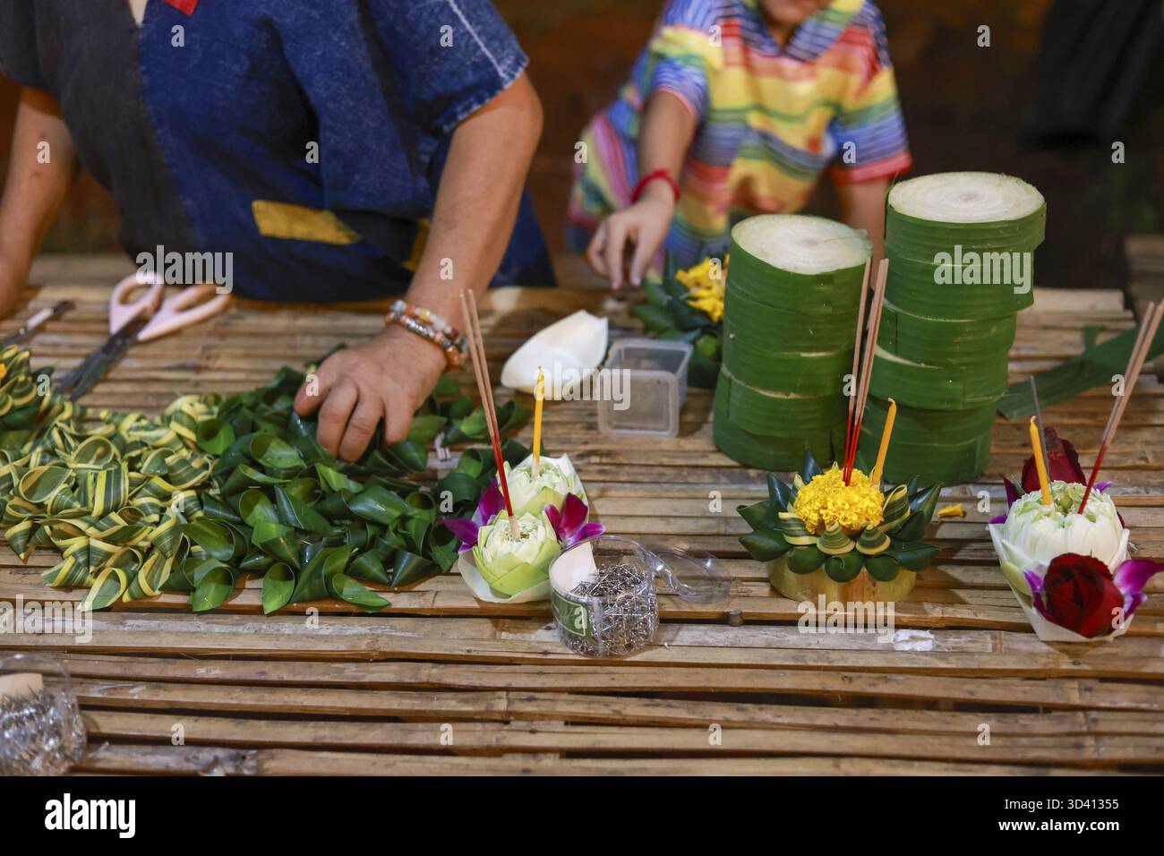 Thai people making traditional krathong for Loy Krathong festival in ...