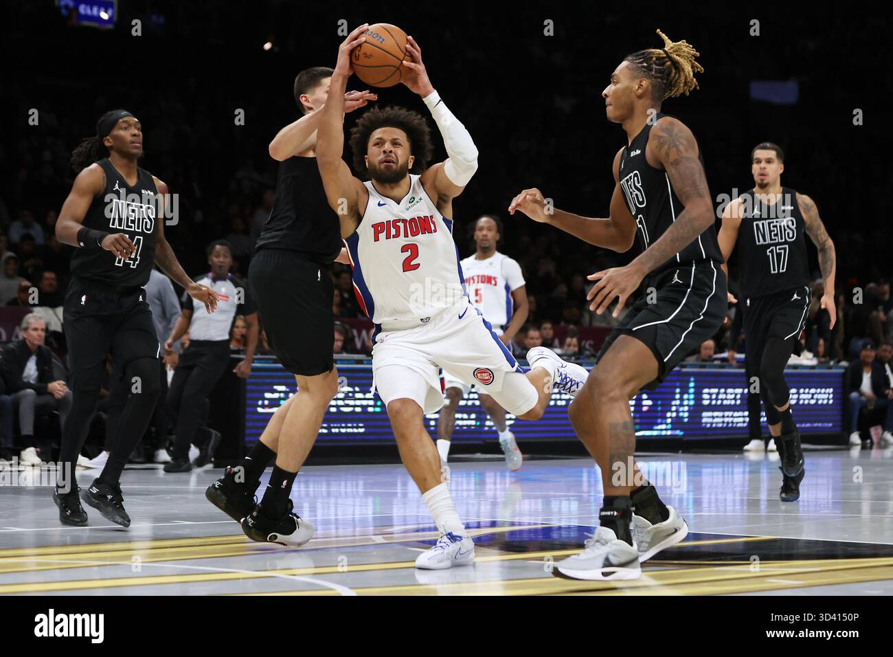 Detroit Pistons guard Cade Cunningham (2) drives to the basket past Brooklyn Nets defenders ...